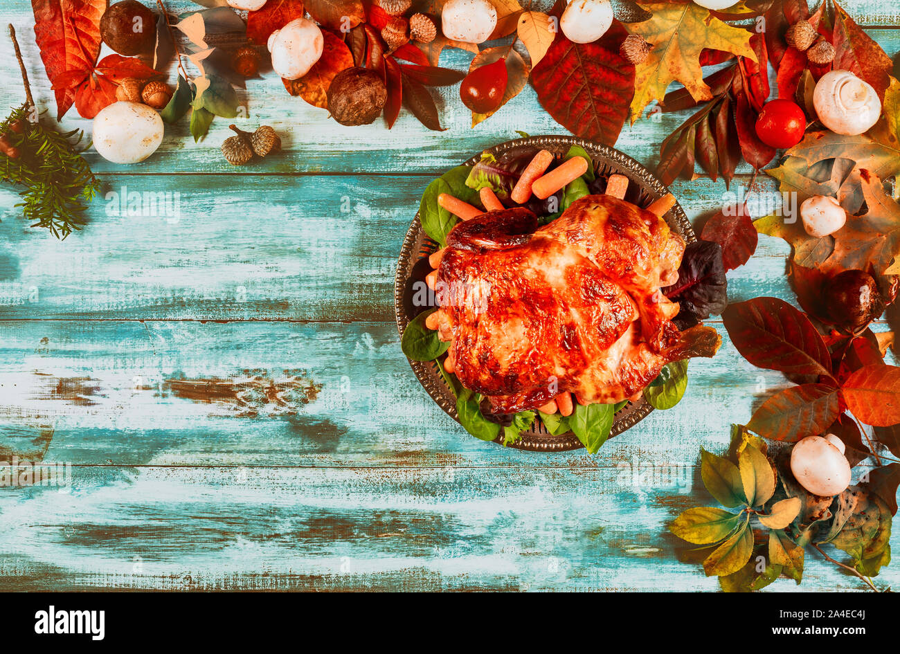 Baked whole fried chicken with mushrooms close-up on a table. vertical ...