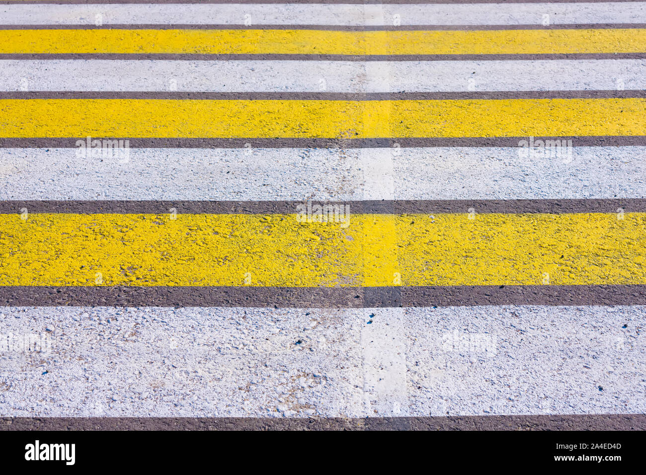 Crosswalk. Yellow and white zebra pedestrian crossing in summer during ...