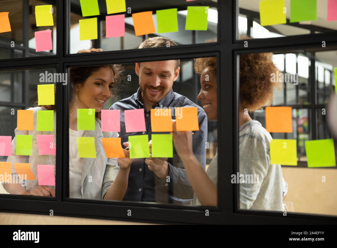 Affiliates using colourful sticky notes writing brief information ...