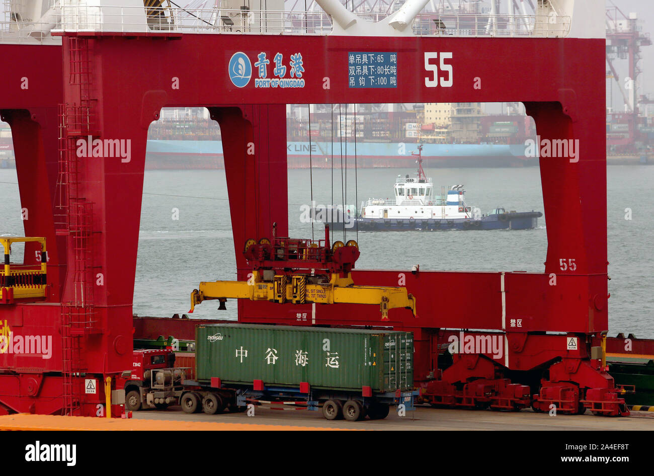 A truck is loaded with a container to be delivered to a designated area ...