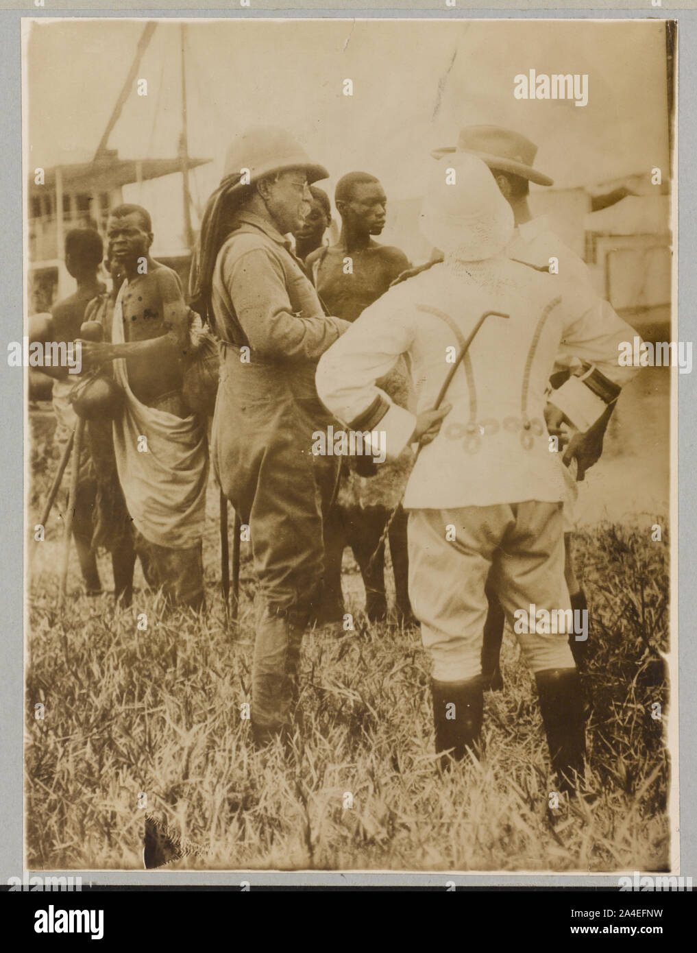 Theodore Roosevelt standing with mostly African men in traditional ...
