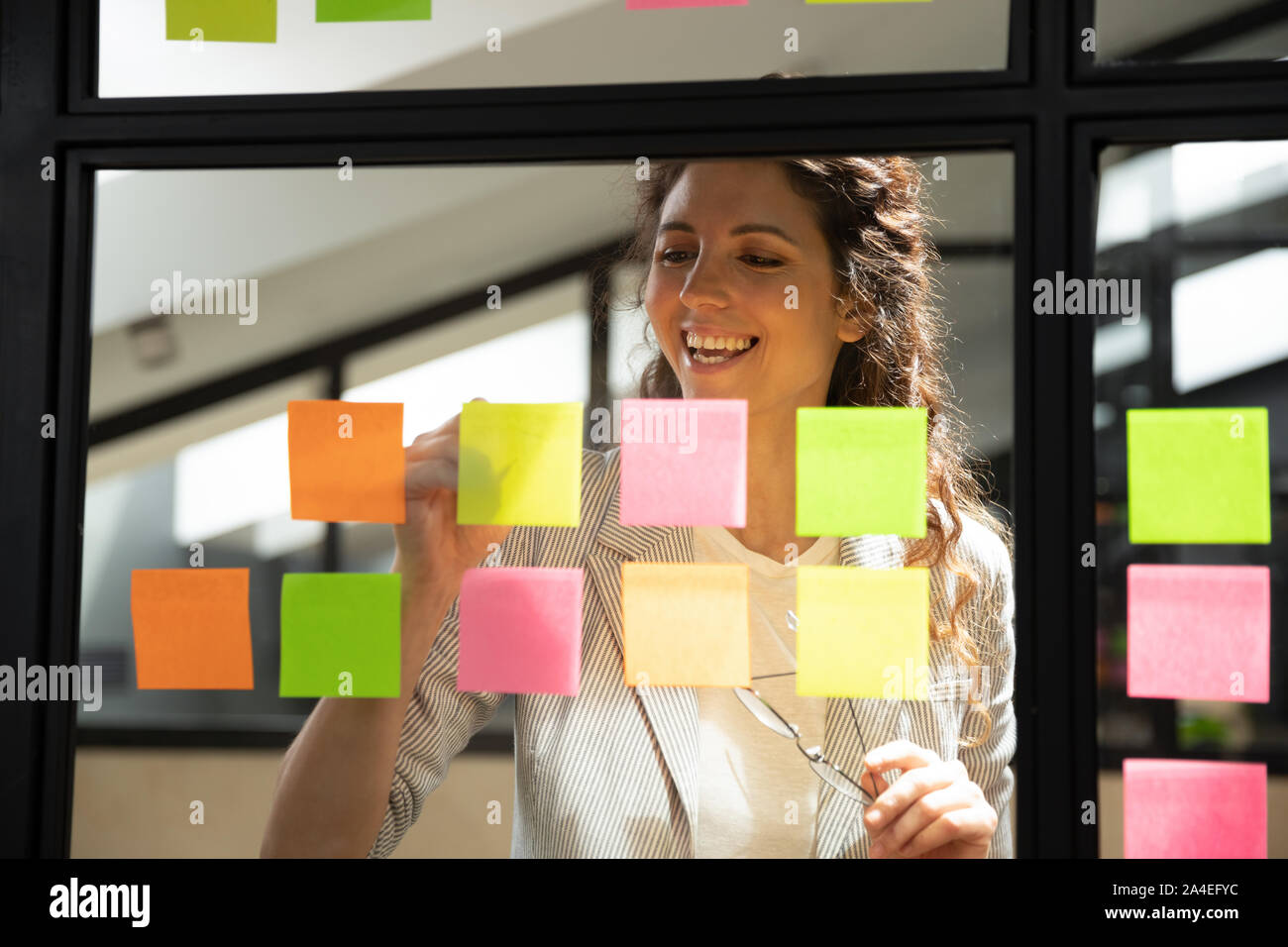 Businesswoman writes creates personal tasks list on sticky notes Stock ...