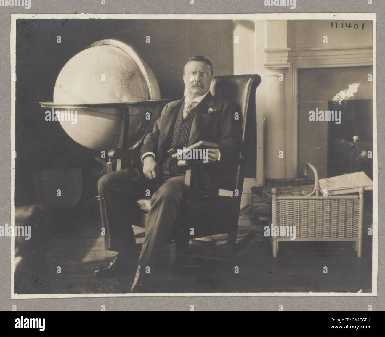 Theodore Roosevelt, full-length portrait, seated next to a globe Stock ...