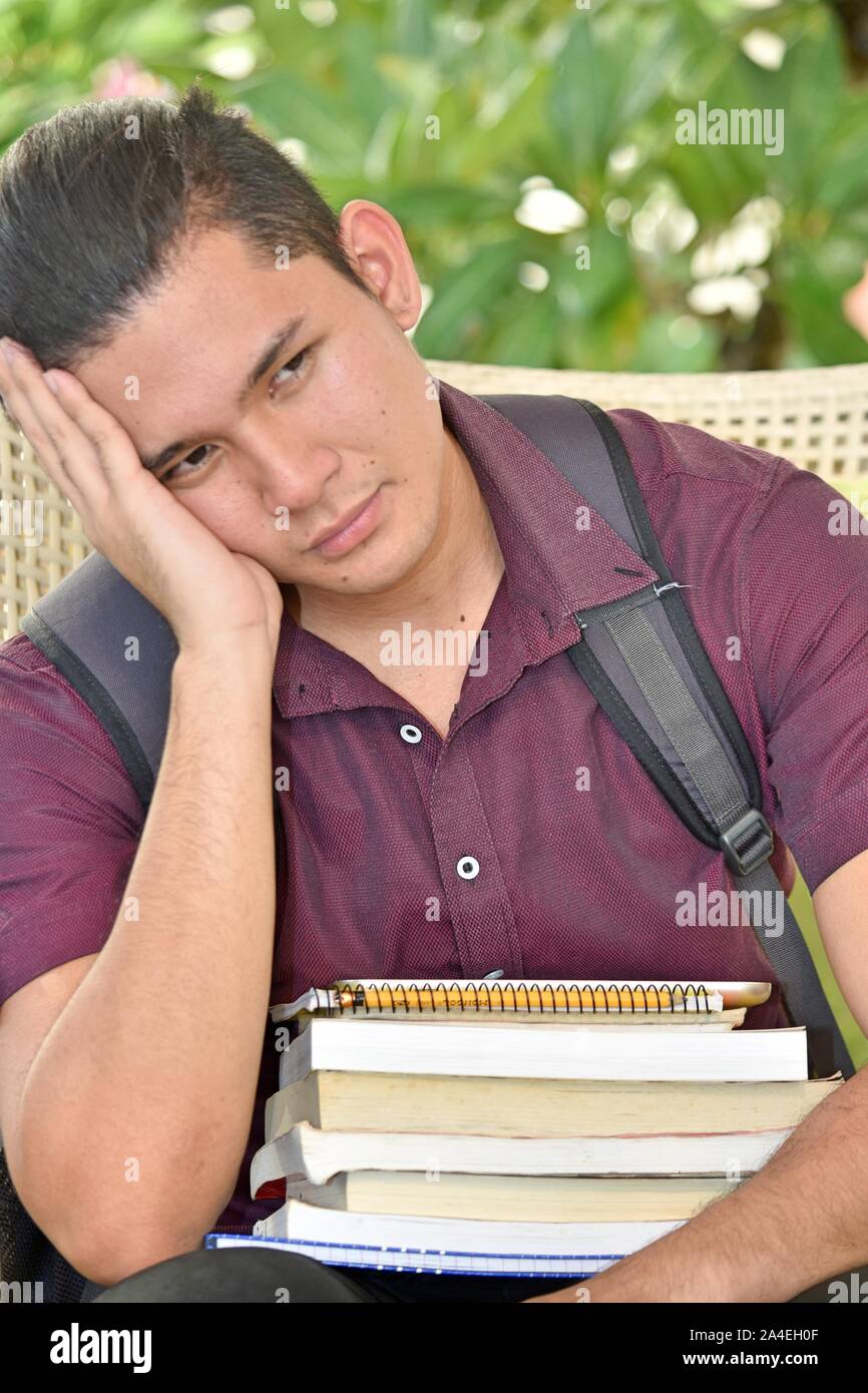 Sad Youthful Filipino Person With Notebooks Stock Photo - Alamy