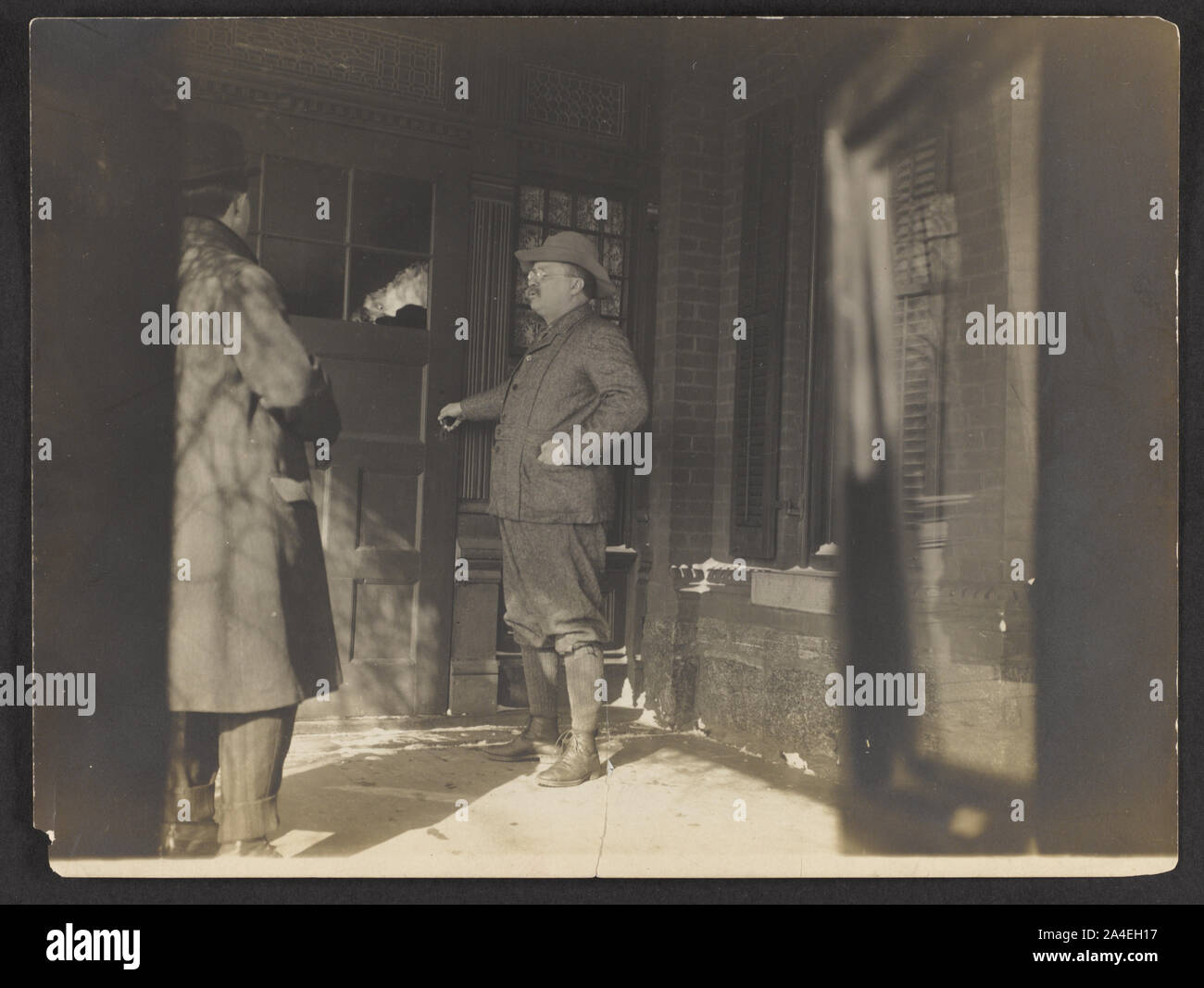 Theodore Roosevelt, full-length, standing, facing left, opening door ...