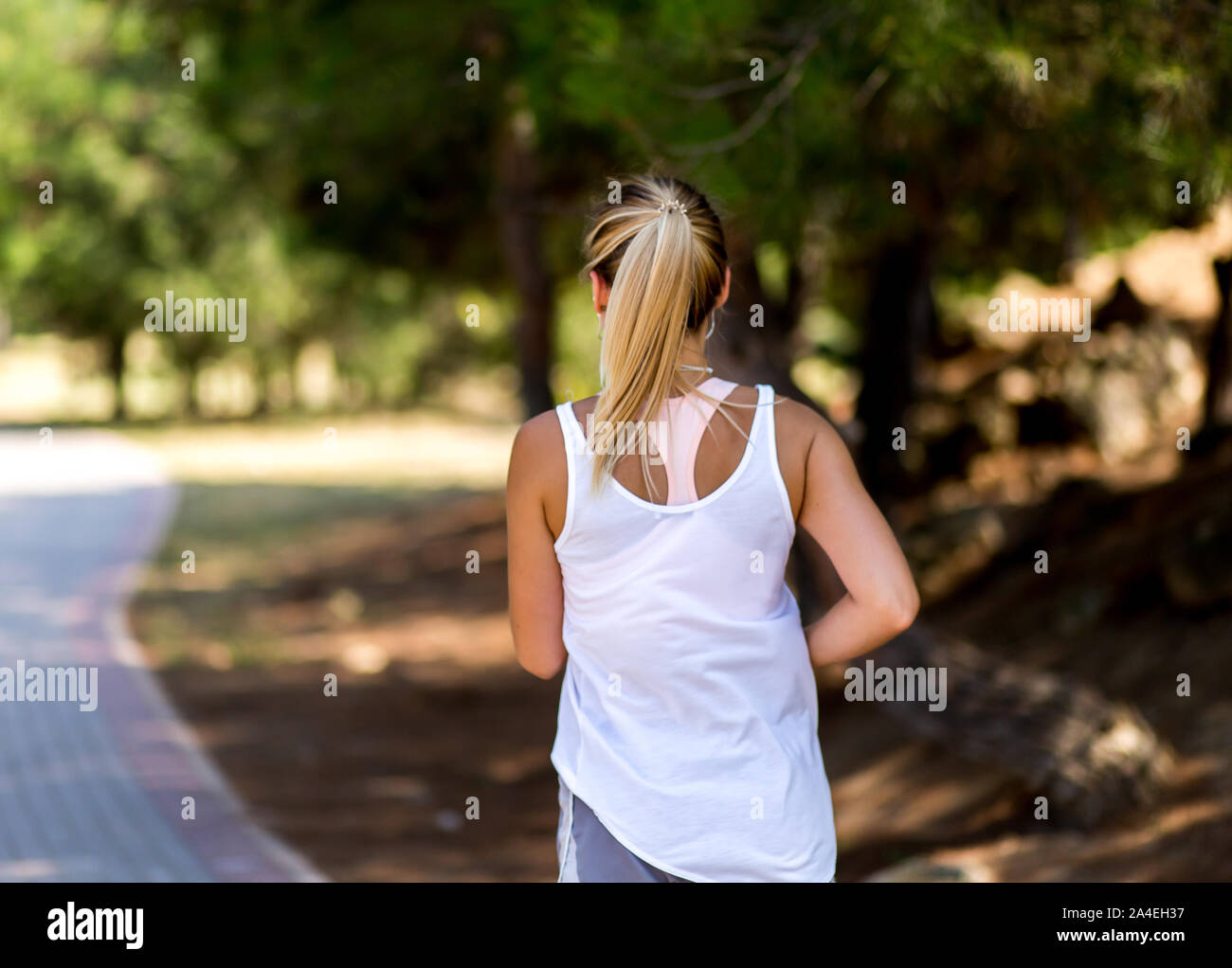 Running woman in park in summer training. Pretty sport fitness model in ...