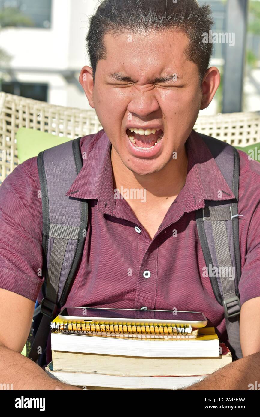 An Asian Male Student Under Stress Stock Photo - Alamy