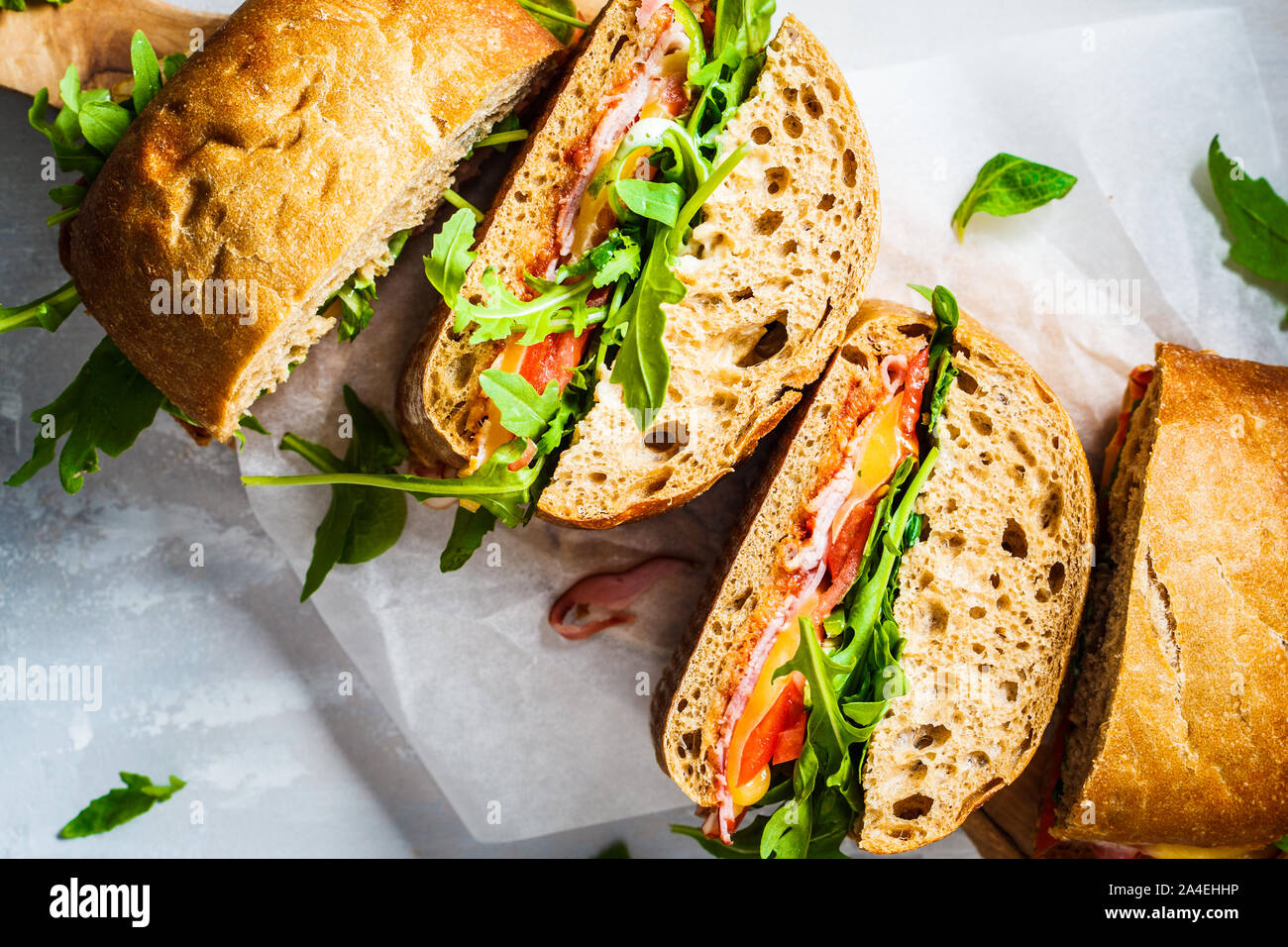 Ciabatta, cheese, ham and vegetable sandwiches on a wooden board Stock ...