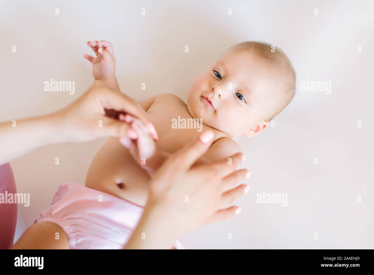 Mother hand massaging forearm of her baby on white background Stock ...