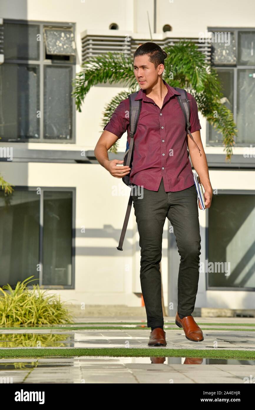 Handsome Male Student Walking On Campus Stock Photo - Alamy