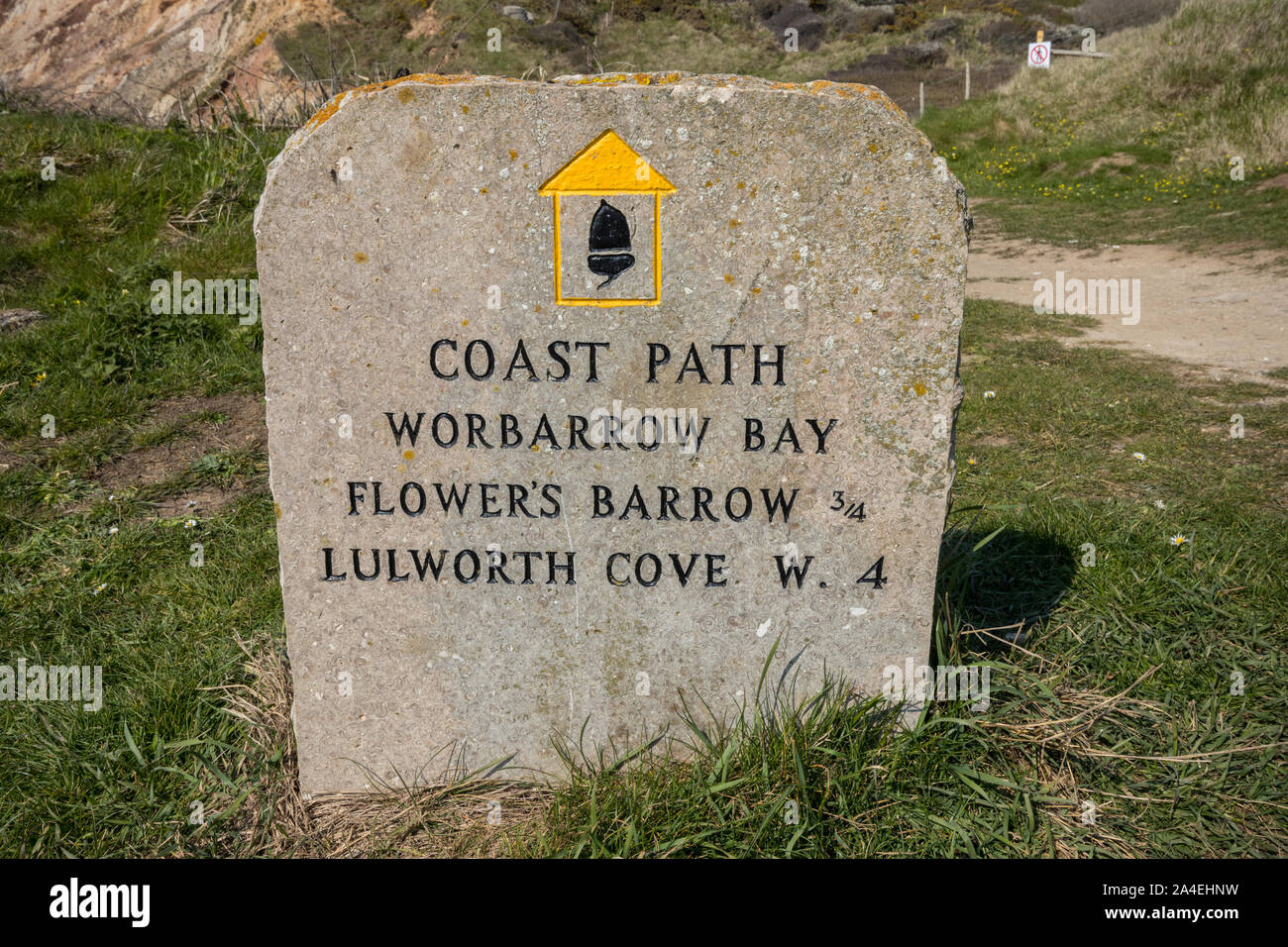 Traditional stone way marker on the South West Coast Path near Tyneham ...