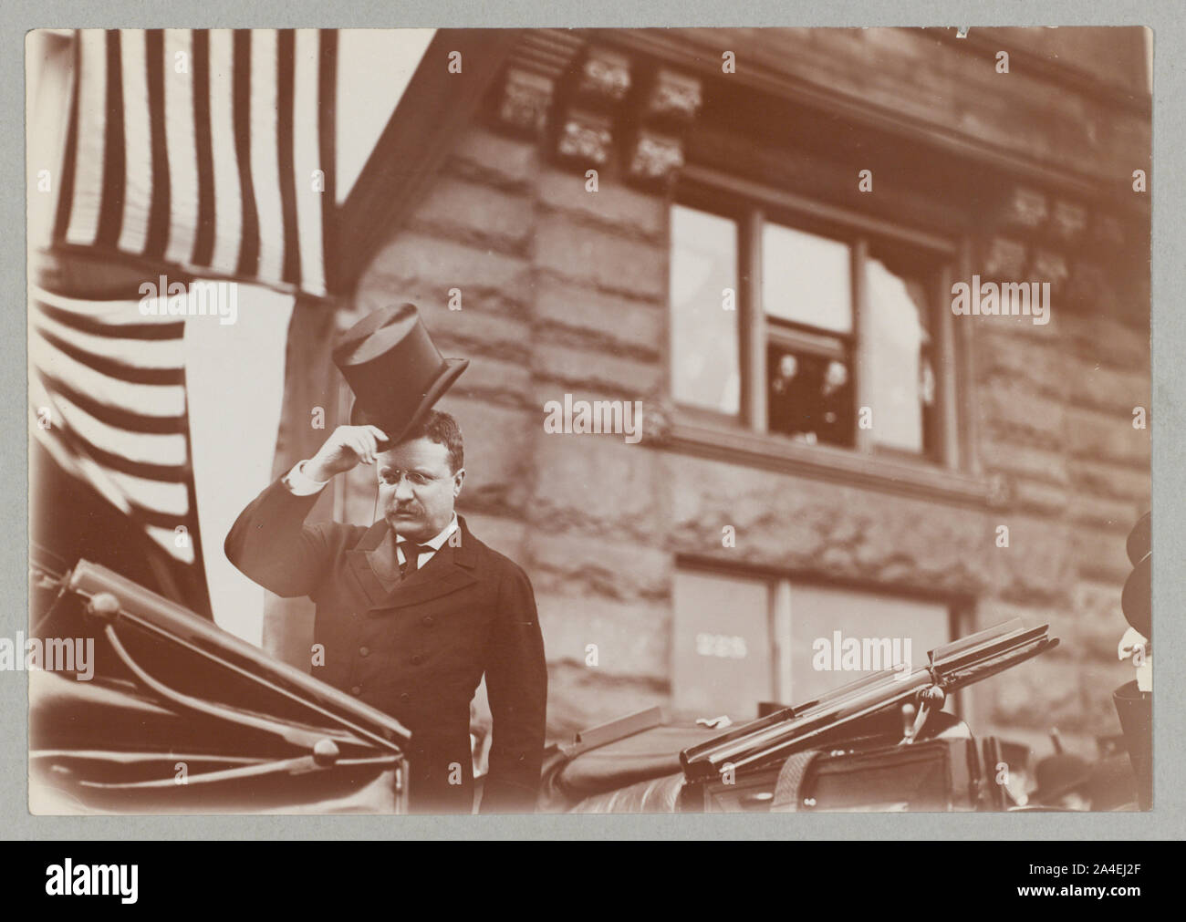 Theodore Roosevelt, standing in open carriage, tipping his hat Stock ...