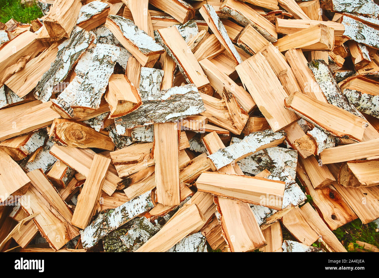 Background of a stack of split logs in a woodpile for use as domestic ...