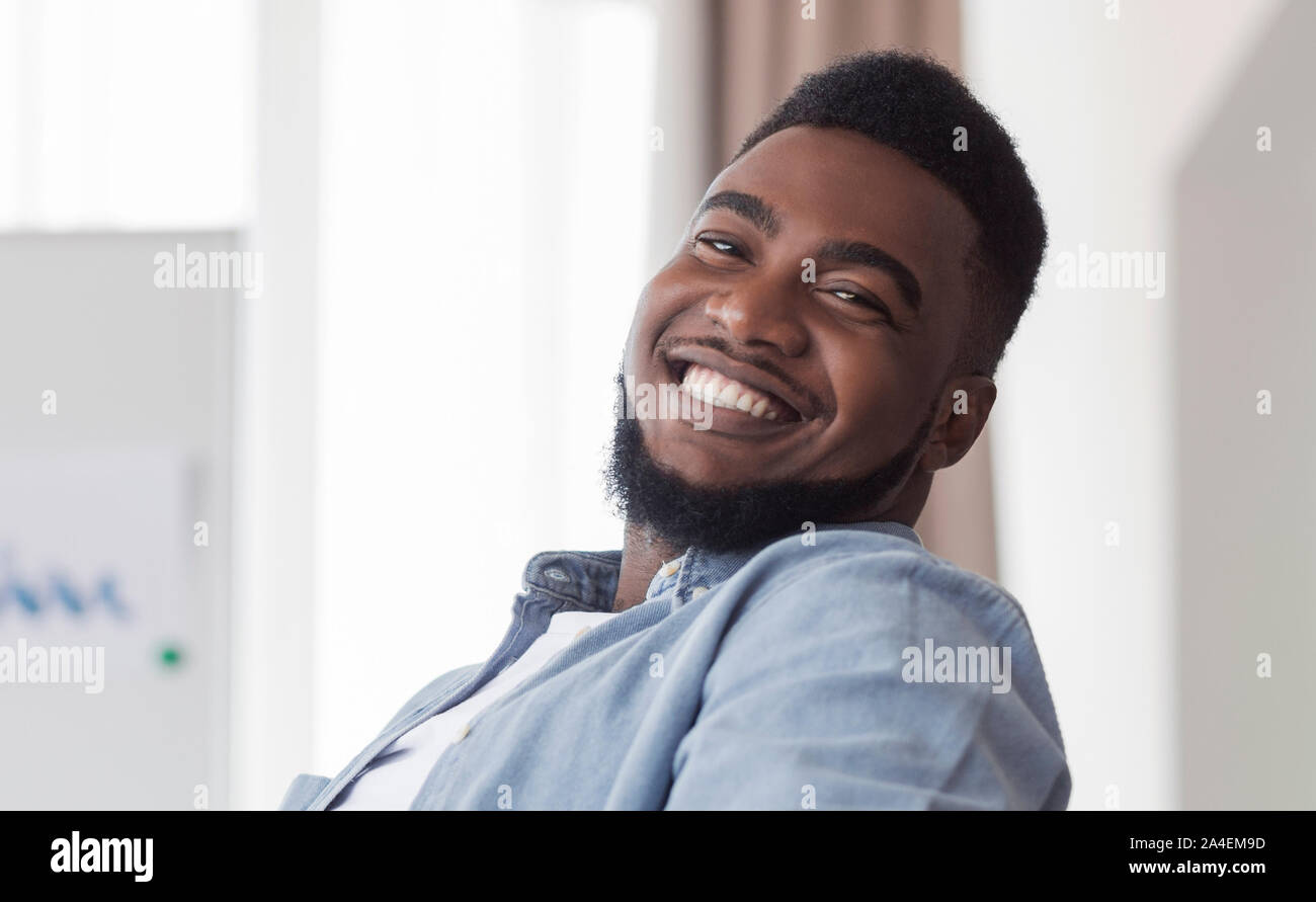 Closeup portrait of cheerful african american guy indoors Stock Photo ...
