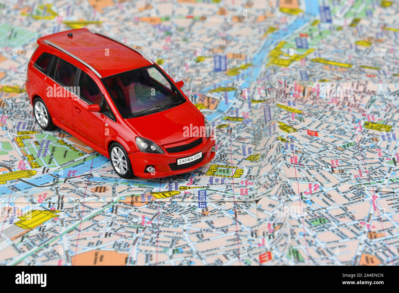 Close-up of a red car on a tourist map background. The concept of car ...