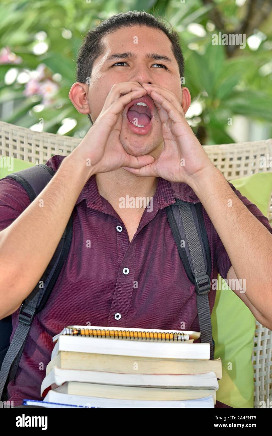 An University Student Yelling With Books Stock Photo - Alamy