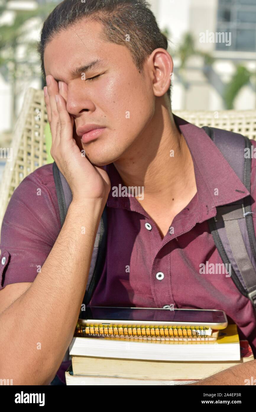 Sad Male Student With Notebooks Stock Photo - Alamy