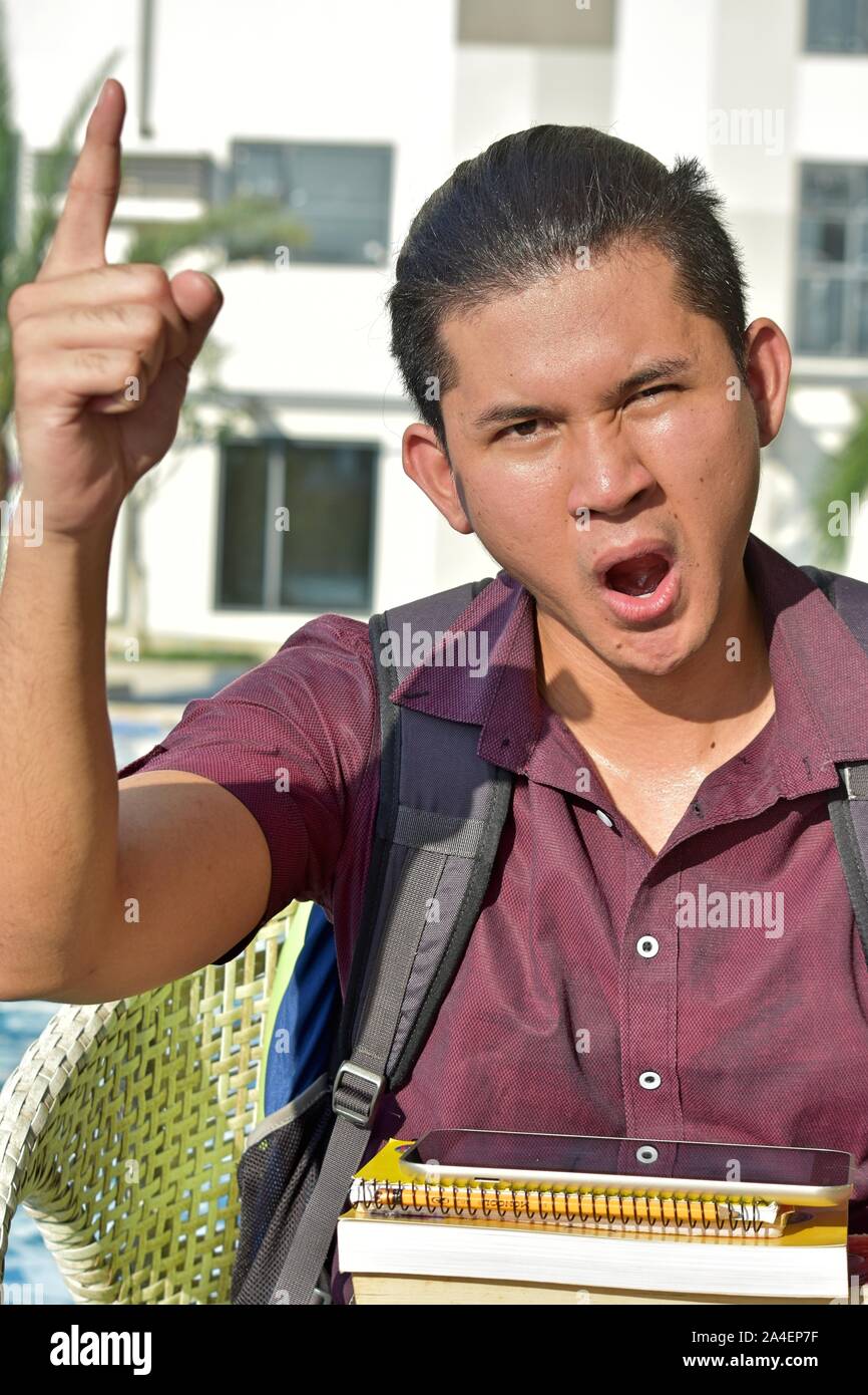 An Angry Boy Student With Notebooks Stock Photo - Alamy