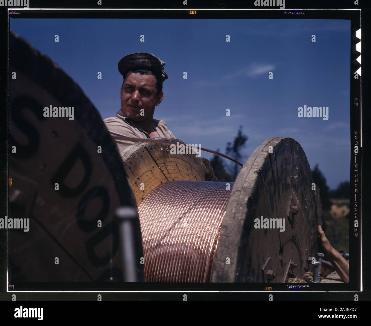 This husky member of a construction crew building a new 33,000-volt ...