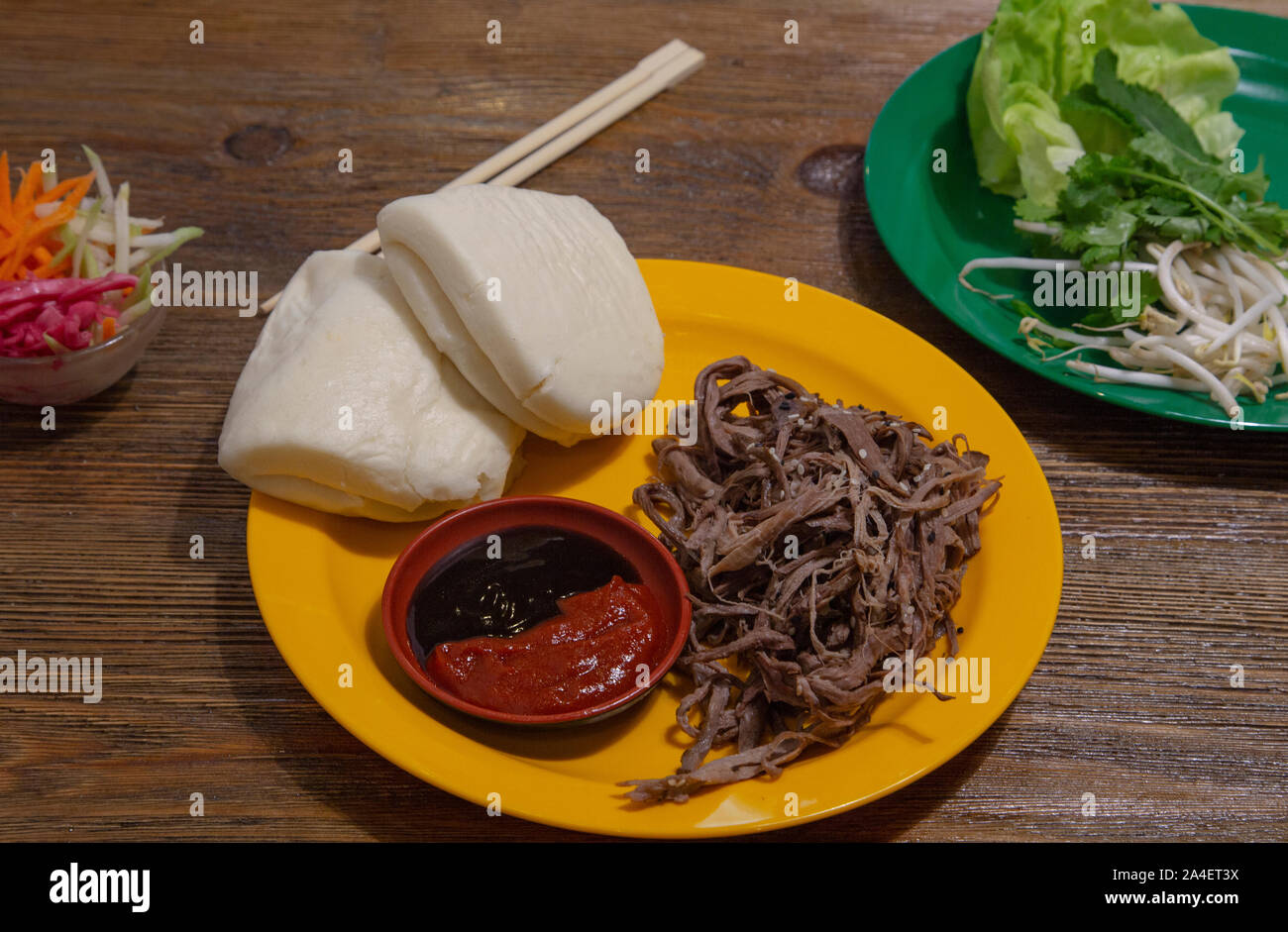 Slow cooked pulled beef with sauces in a bao bun Stock Photo - Alamy