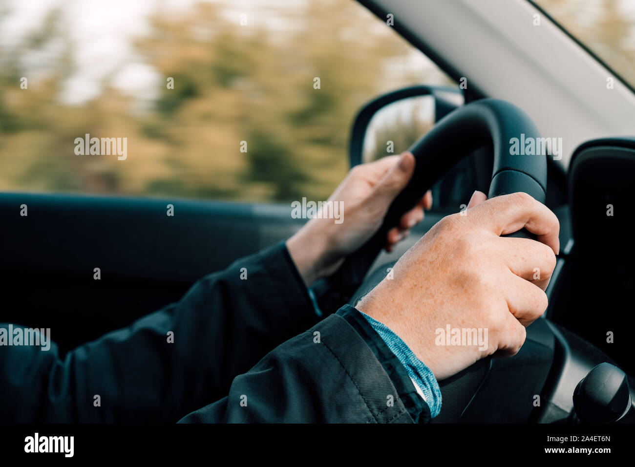 Female hands on steering wheel, woman driving through countryside Stock ...