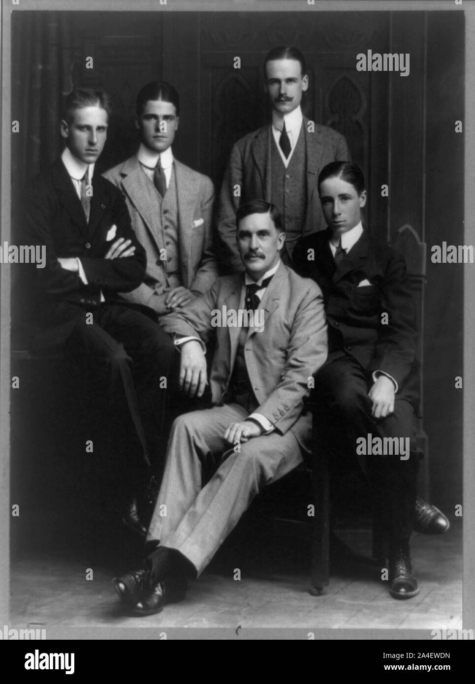 Four children seated Black and White Stock Photos & Images - Alamy