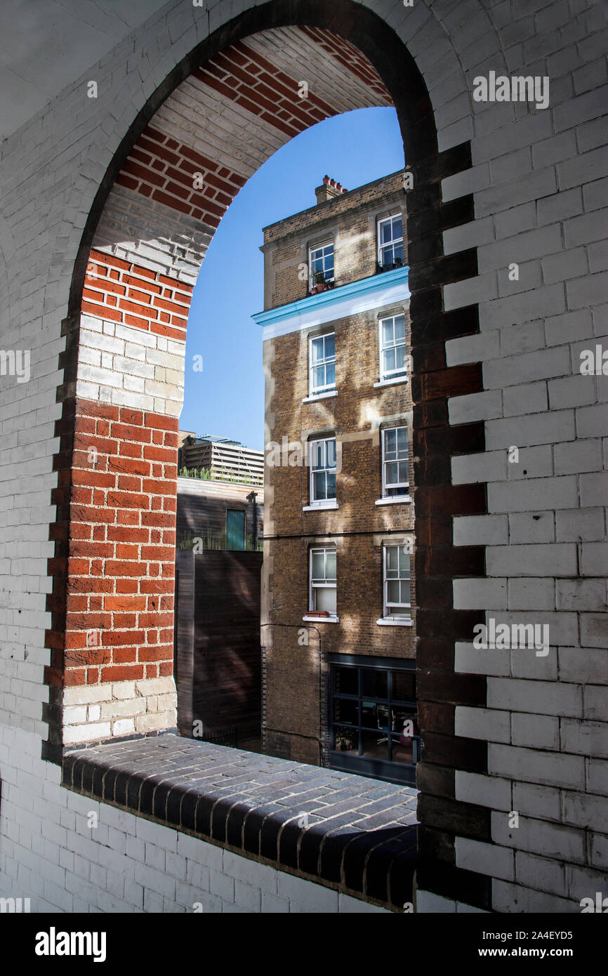 building seen through victorian archway Stock Photo - Alamy