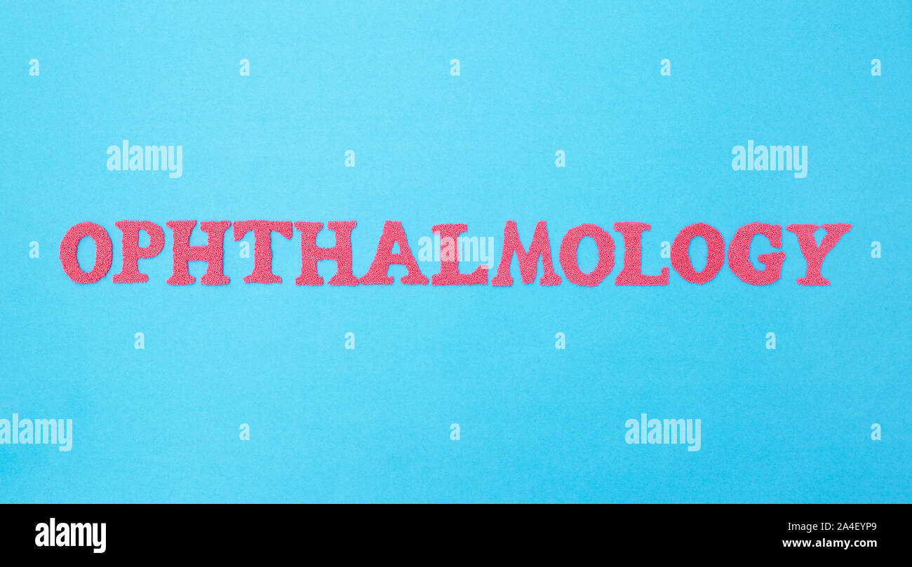 Ophthalmology inscription in red letters on a blue background. A branch ...