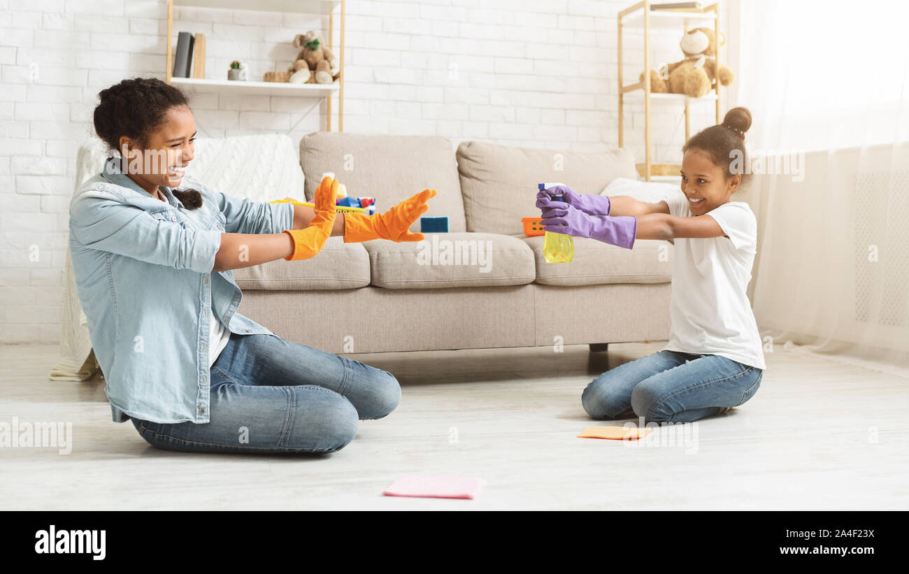 Playful girls having fun during cleaning home Stock Photo - Alamy