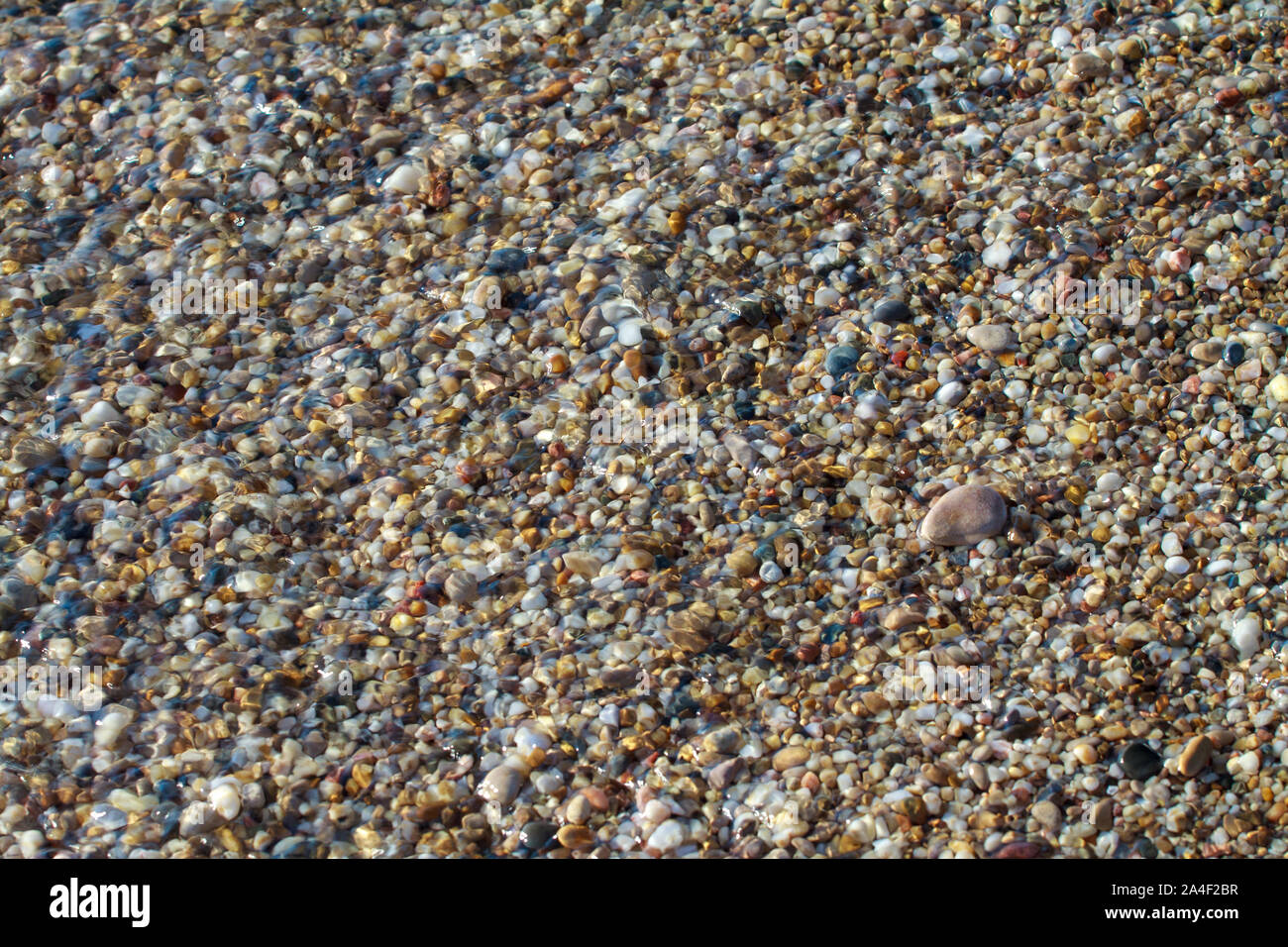sea pebbles colored granite on the beach background stones. The shore ...