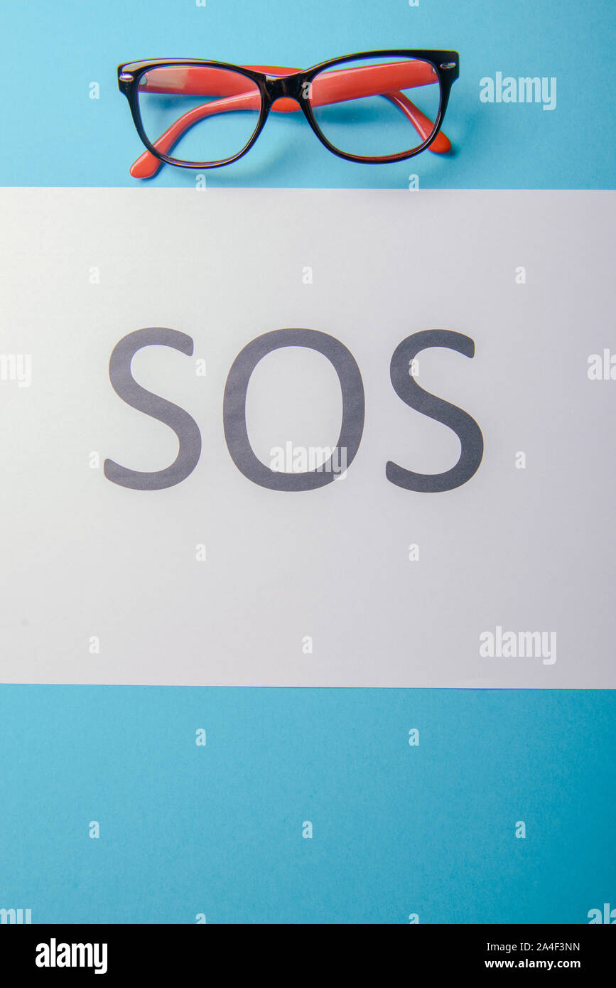 Word SOS written on white paper. Blue background Stock Photo - Alamy