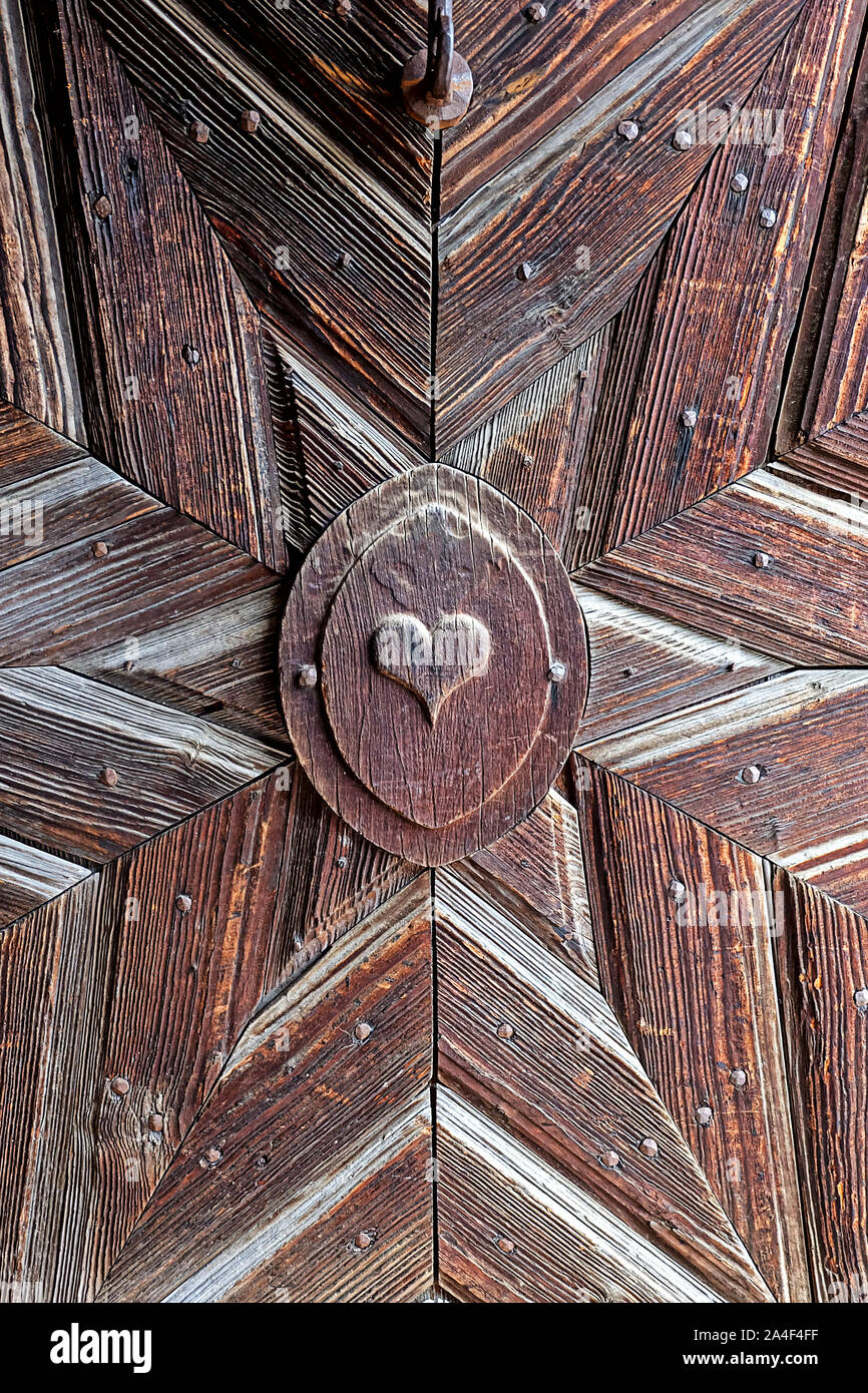 Welcome at the front door, old wooden door with star pattern and carved ...