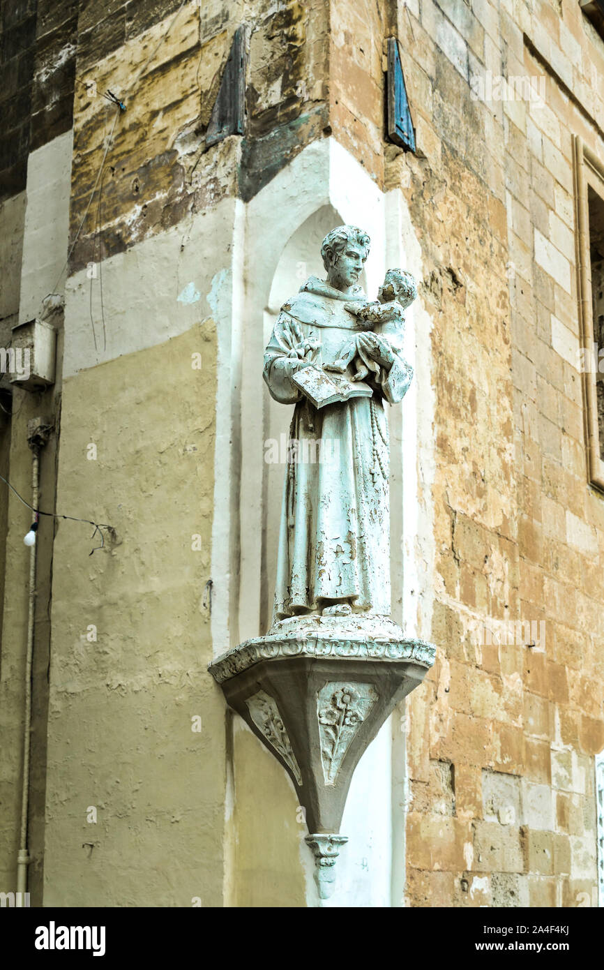 One of the hundreds of street niches with statues of saints on the ...