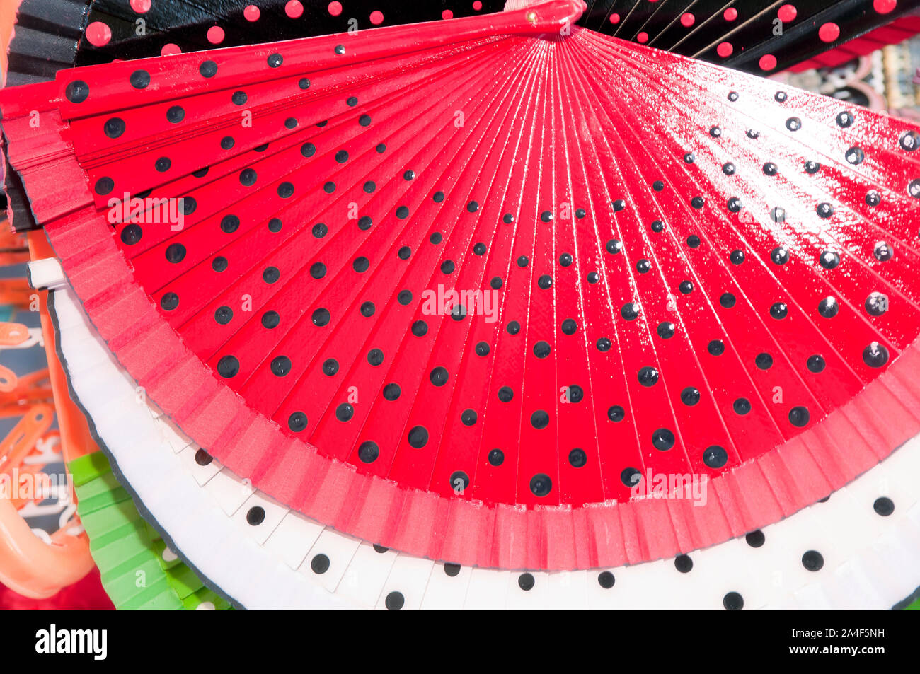 Handmade colored fans with dots Stock Photo - Alamy