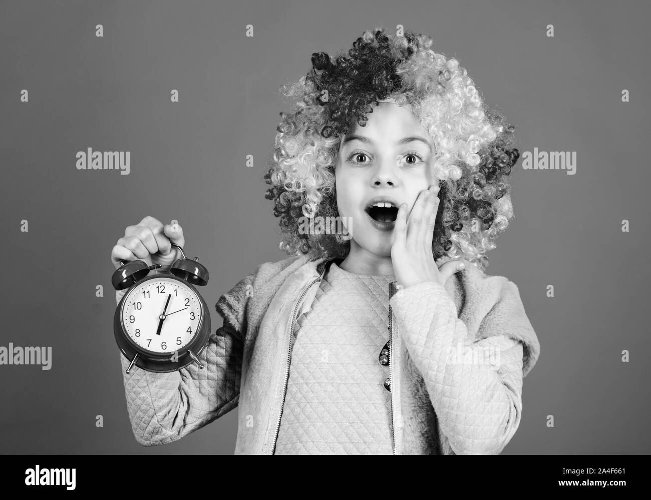 Kid colorful curly wig clown style hold alarm clock. I am not joking ...