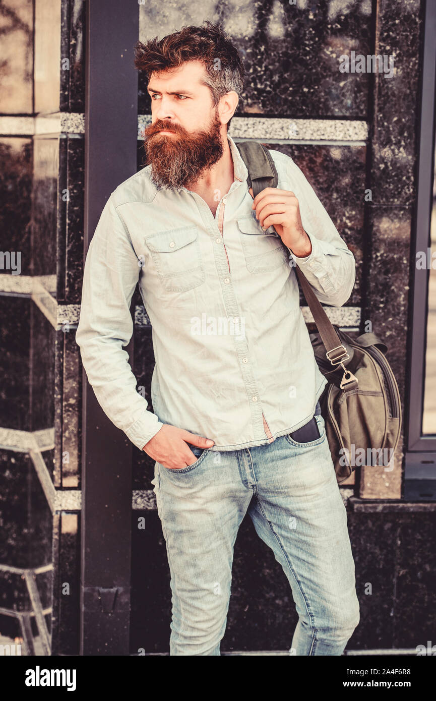 Carry things in big bag on shoulder. Muscular man with beard and ...