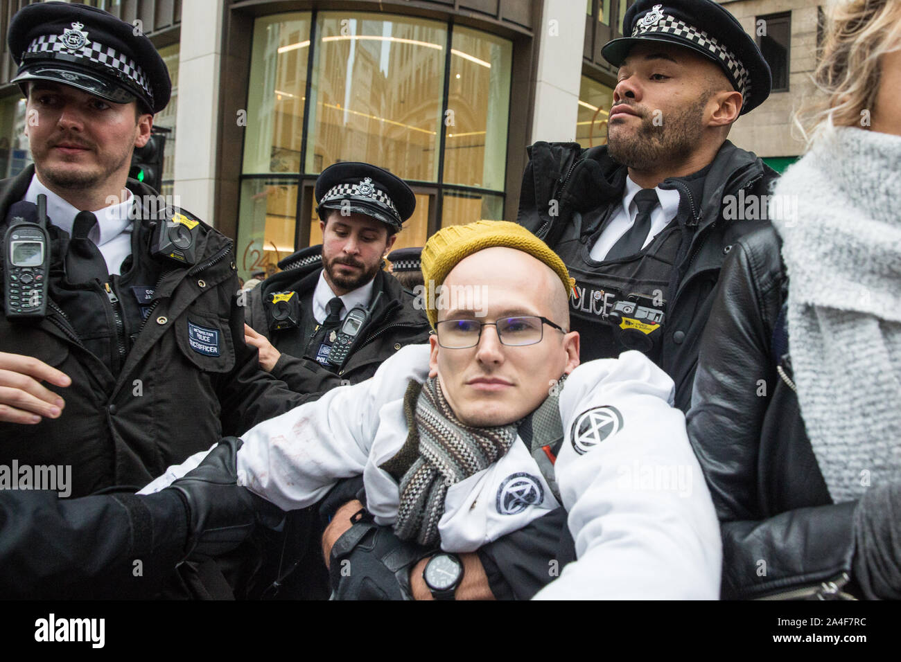 London, UK. 14 October, 2019. Police officers arrest a climate activist ...