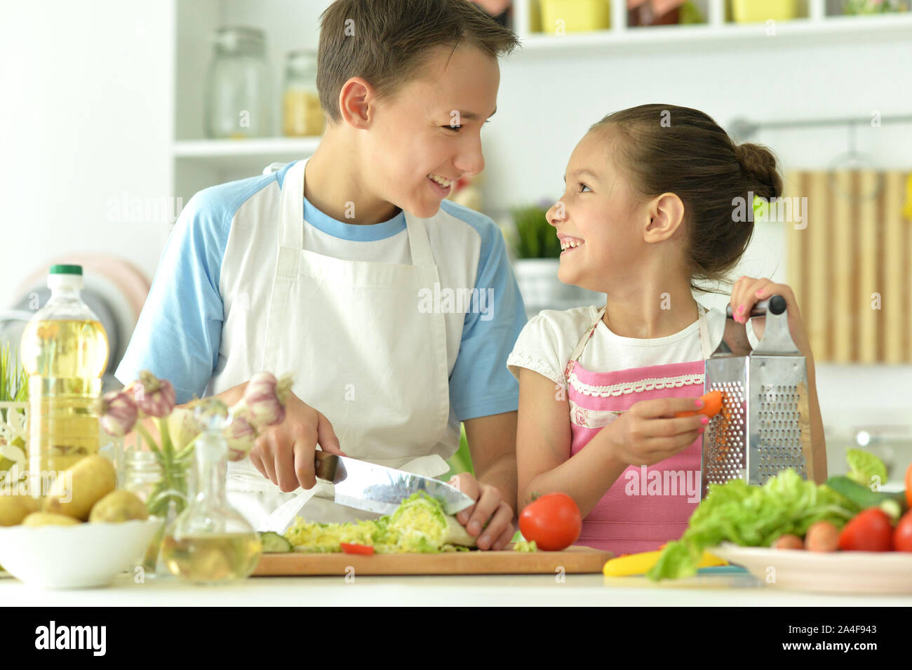 Cute brother and sister cooking together in kitchen Stock Photo - Alamy