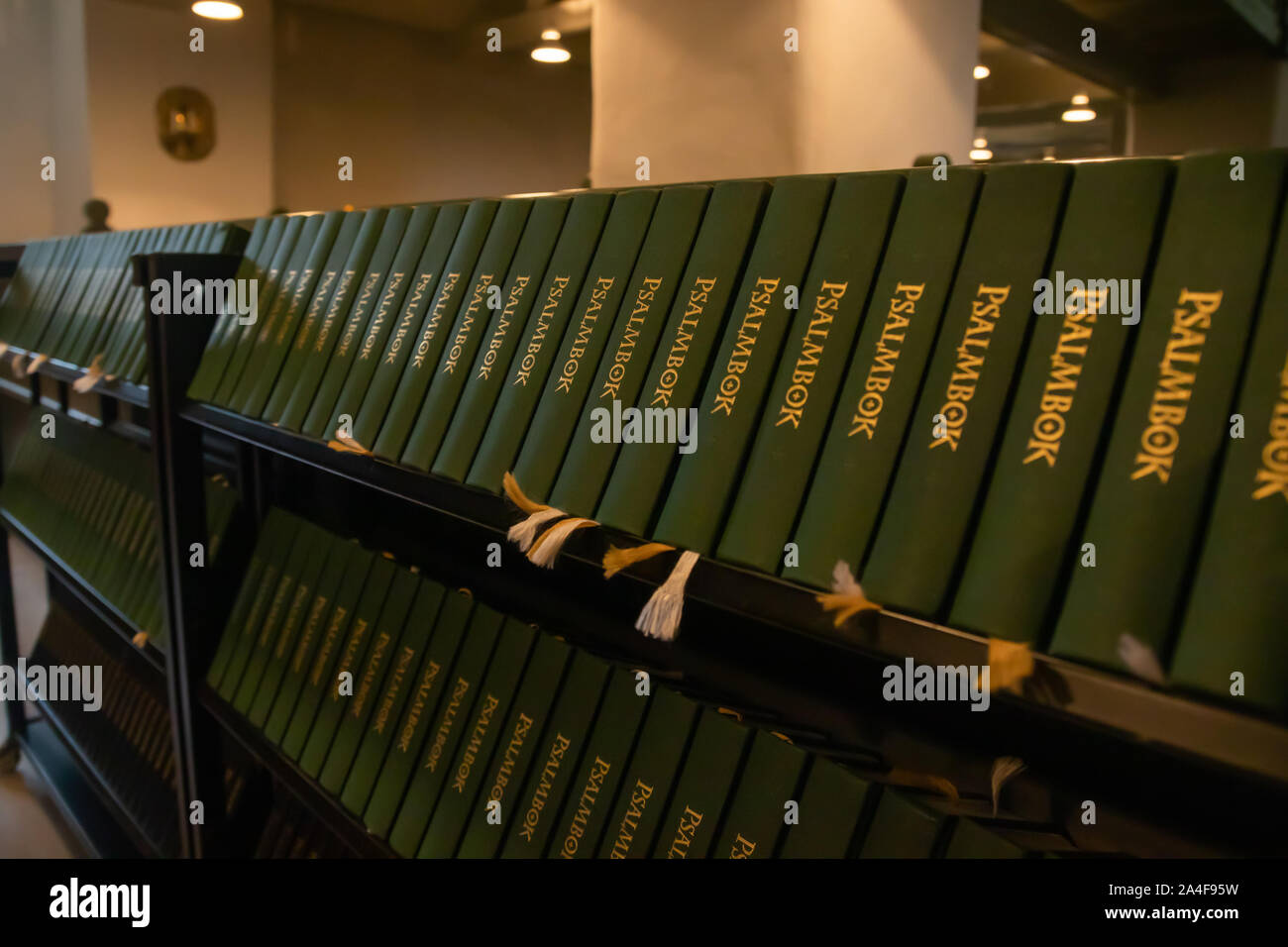 Porvoo, Finland - 2 October 2019: Closeup of a row of green hymn books ...