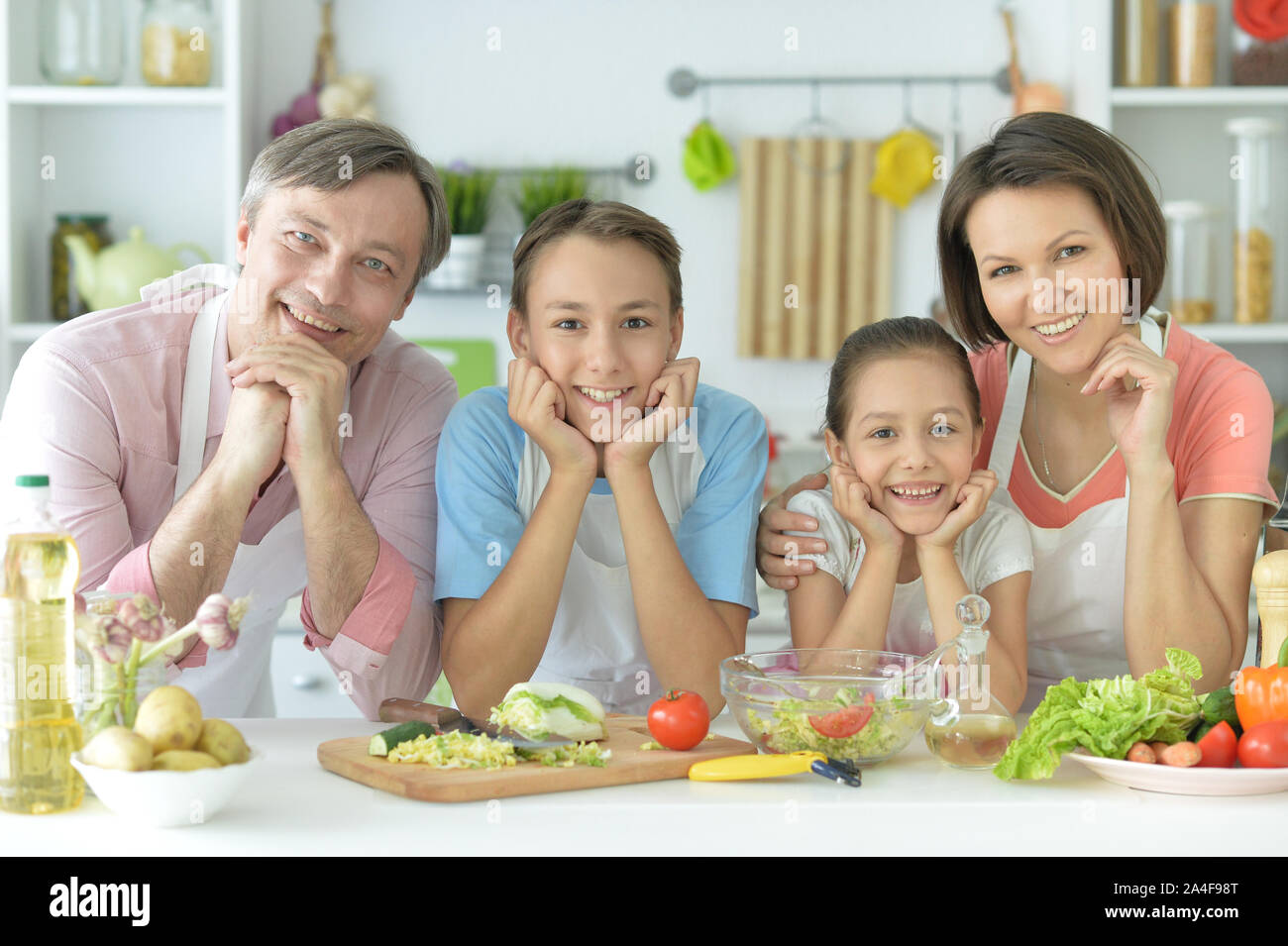 Cute family cooking together in kitchen Stock Photo - Alamy