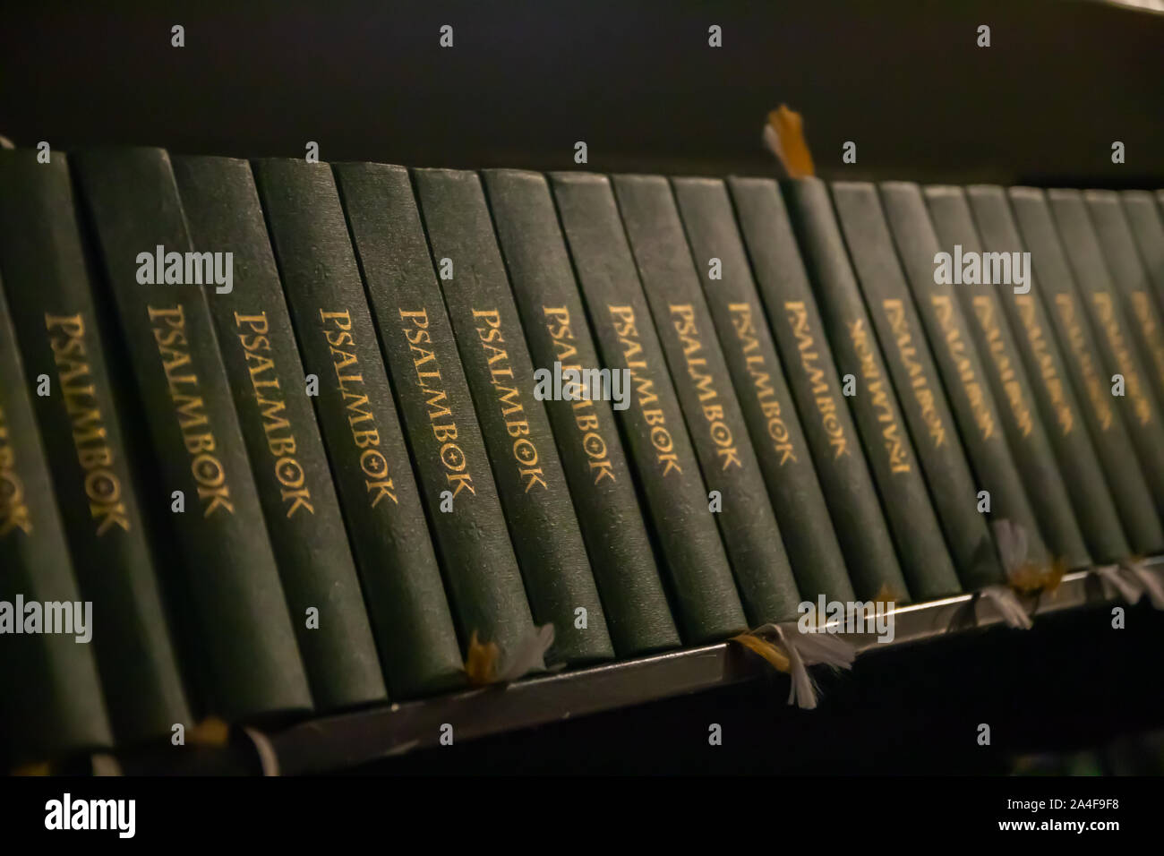 Porvoo, Finland - 2 October 2019: Closeup of a row of green hymn books ...