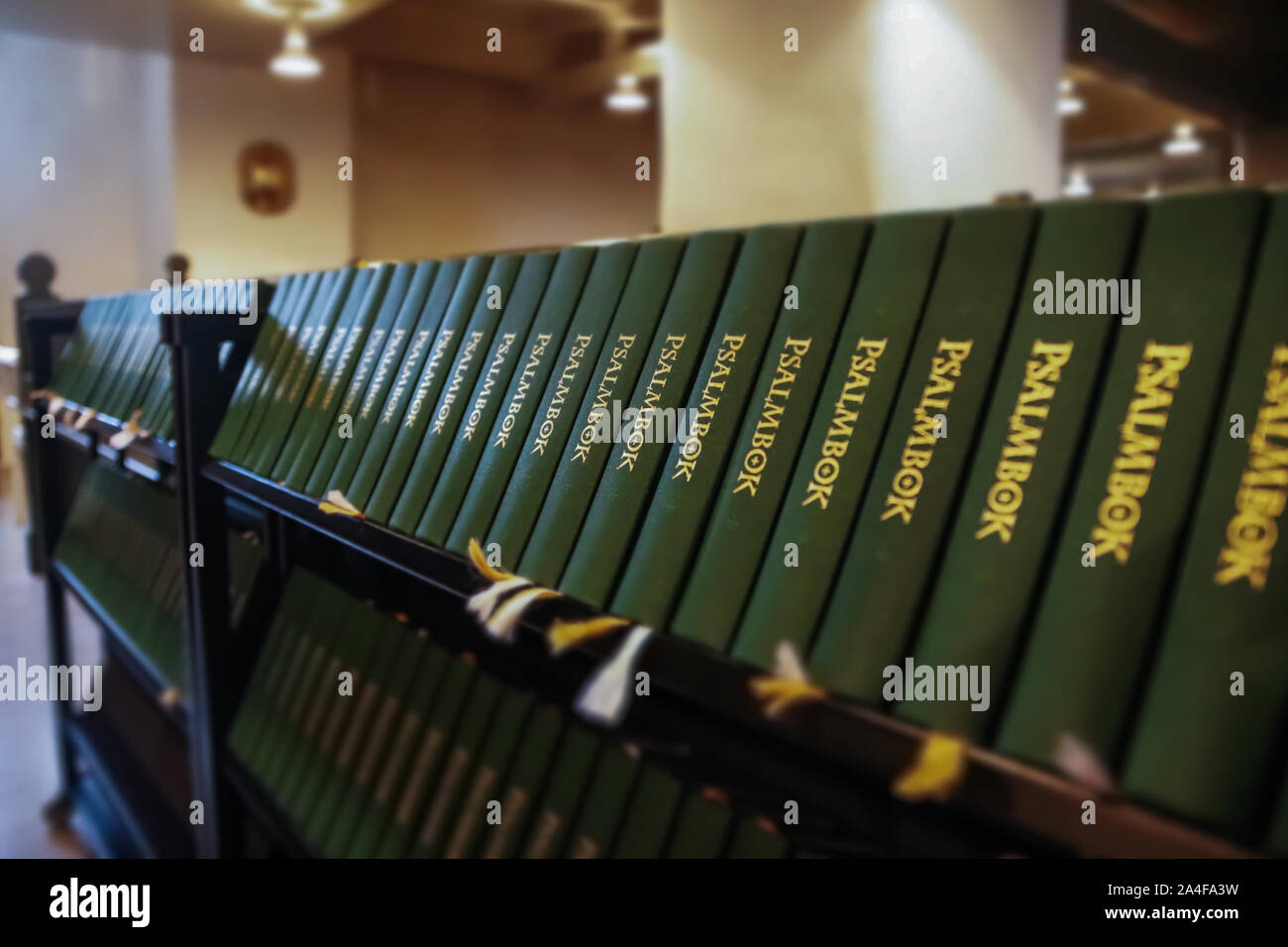 Porvoo, Finland - 2 October 2019: Closeup of a row of green hymn books ...
