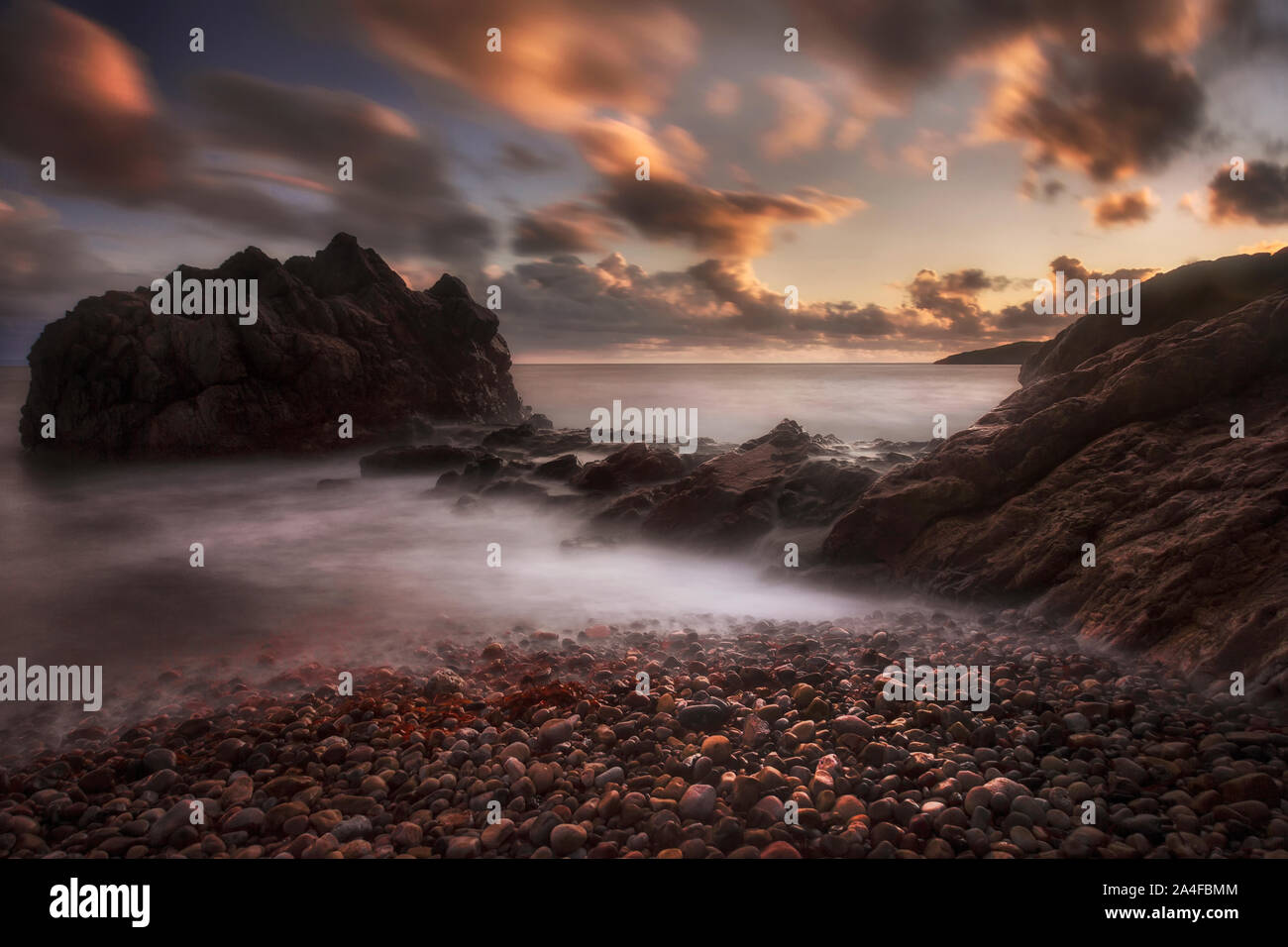 Sunset on Rotherslade Bay Stock Photo - Alamy