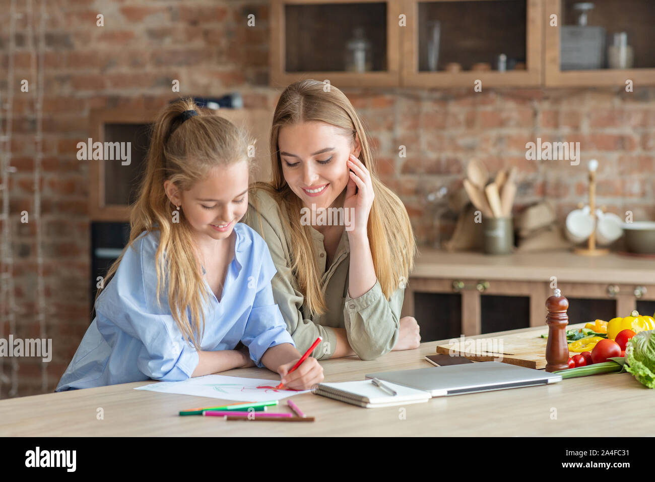 Creative mommy and daughter painting in kitchen Stock Photo - Alamy