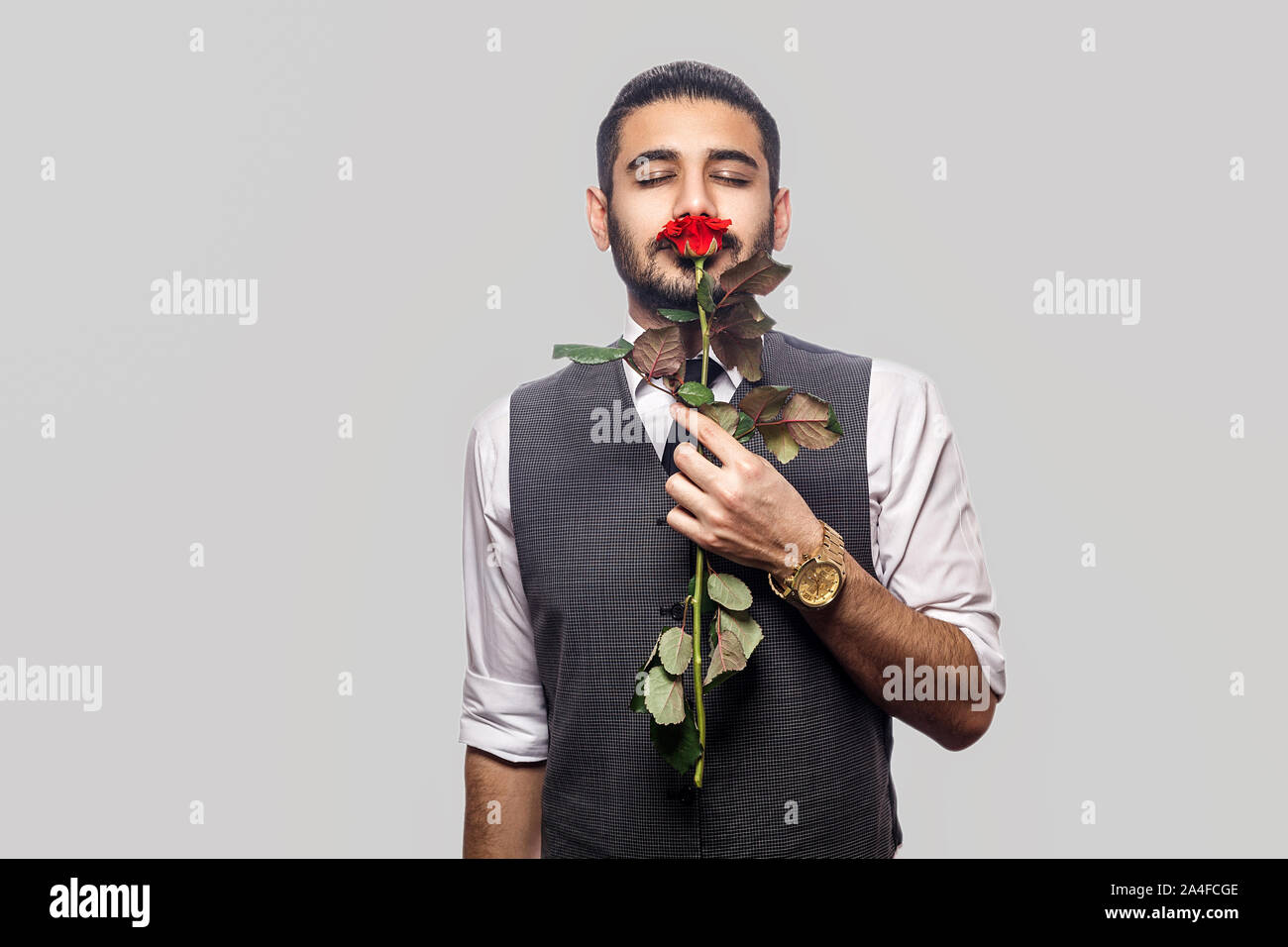 Portrait of handsome bearded brunette man in white shirt and waistcoat ...
