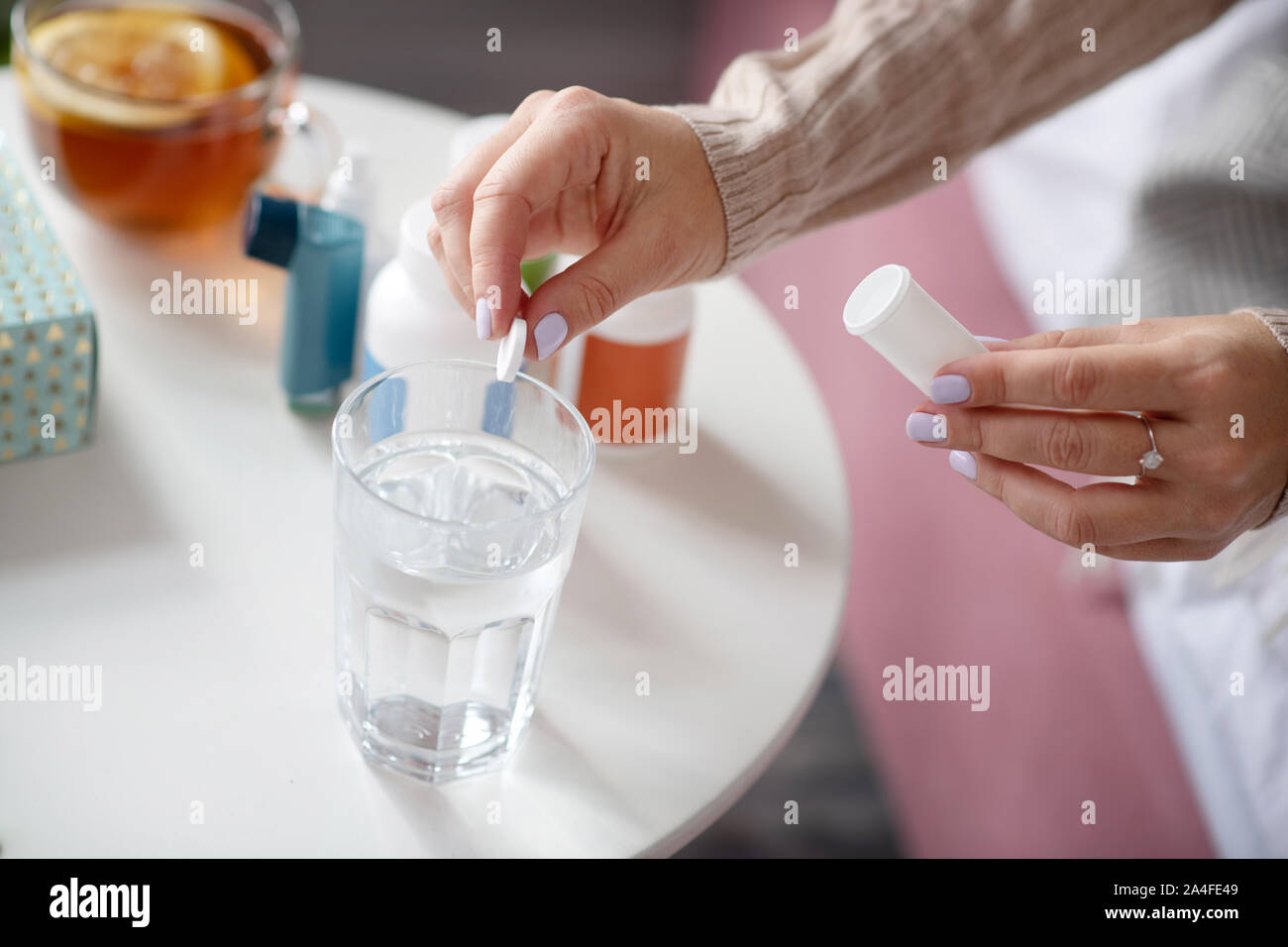 Woman putting pill into glass of water after doctors instructions Stock ...