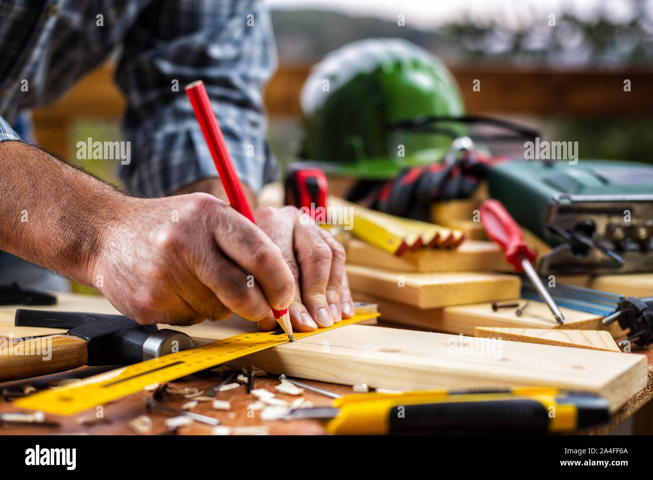 Adult carpenter craftsman with a pencil and the carpenter's square ...