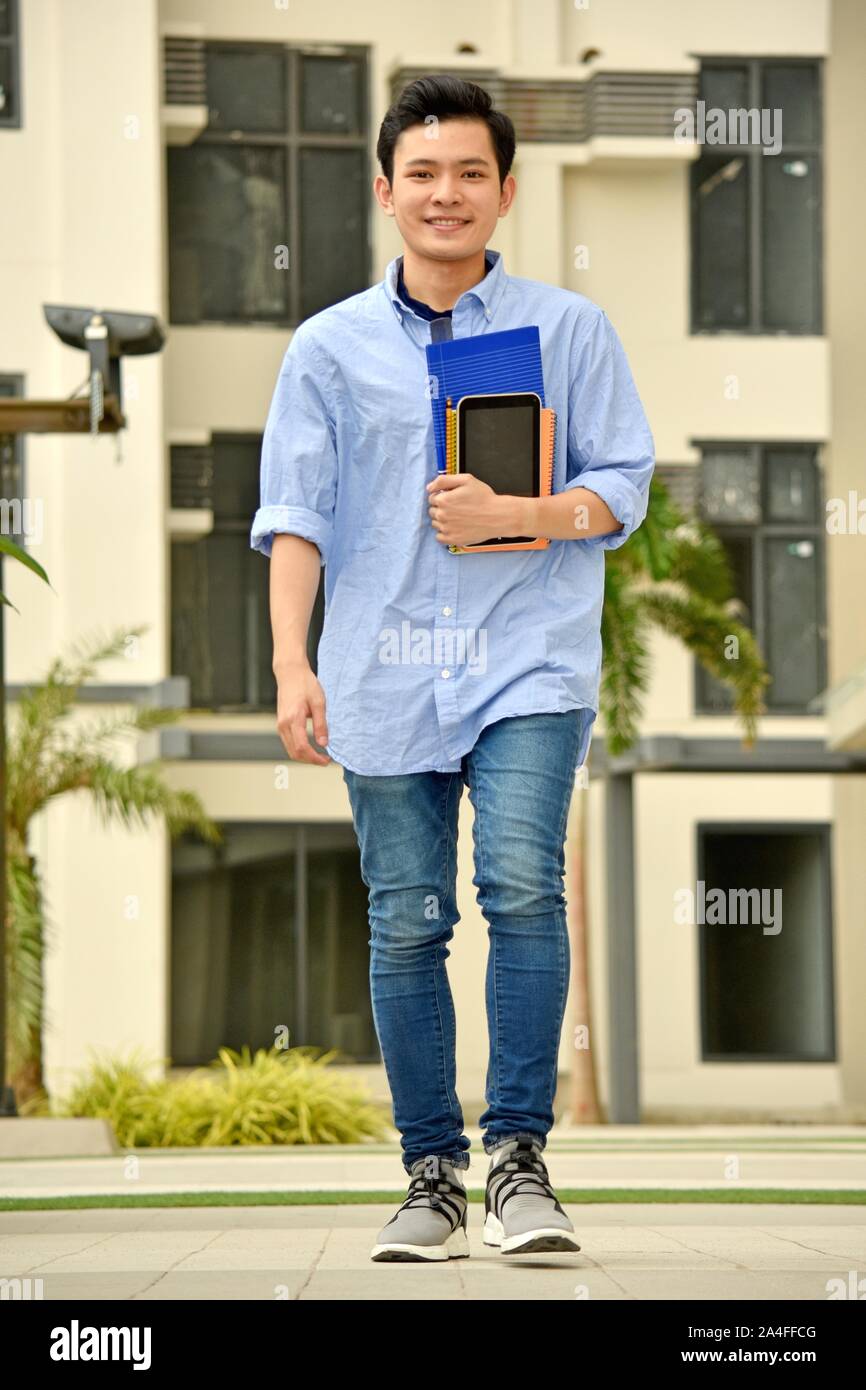 Smiling College Diverse Male Student With Notebooks Walking On Campus ...
