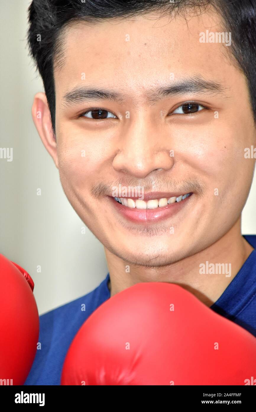 Smiling Asian Male Boxer Wearing Boxing Gloves Stock Photo - Alamy