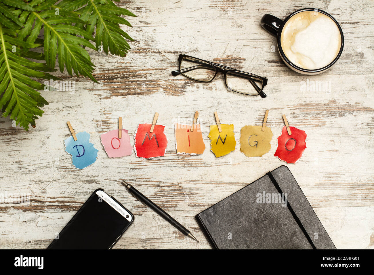 Domingo sign and a cup coffe on a desk (sunday Stock Photo - Alamy